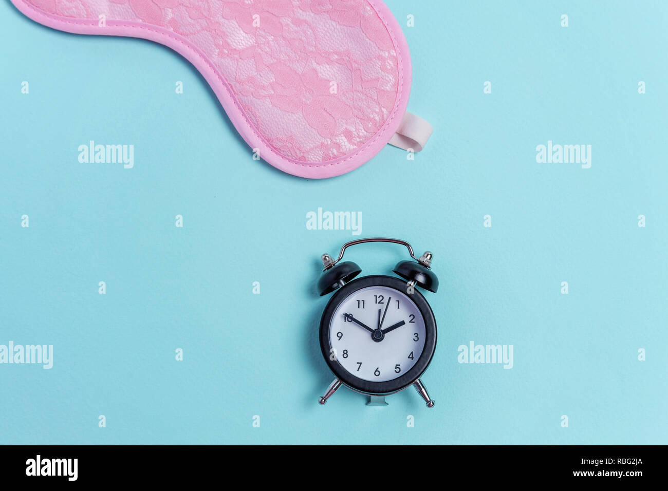 Sleeping eye mask, alarm clock isolated on blue pastel colourful trendy ...