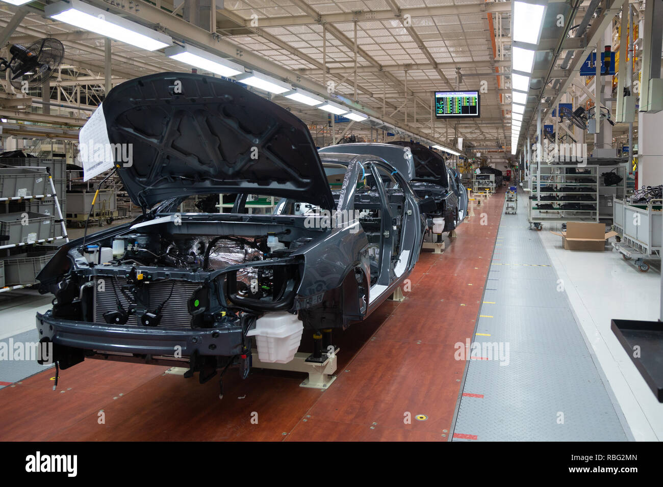 Add details to car body. Robotic equipment makes Assembly of car ...