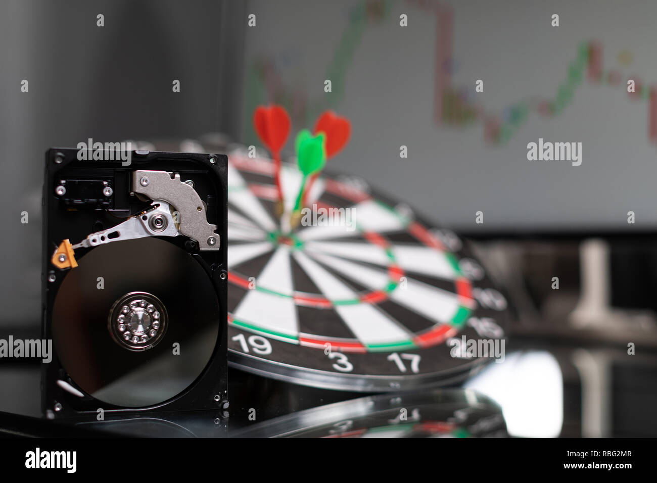 hard drive in background of dart Board with Darts at targets and ...