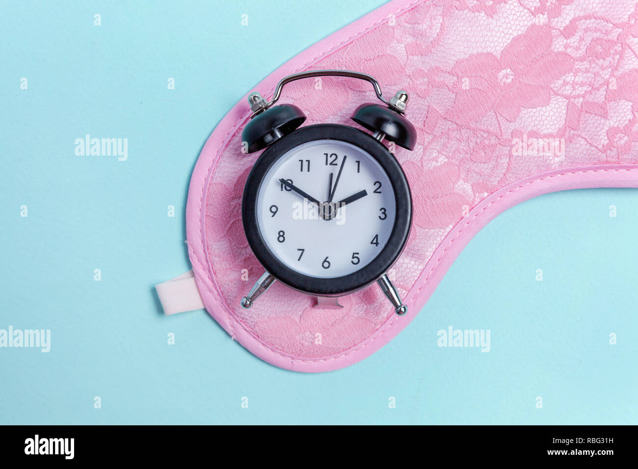 Sleeping eye mask, alarm clock isolated on blue pastel colourful trendy ...