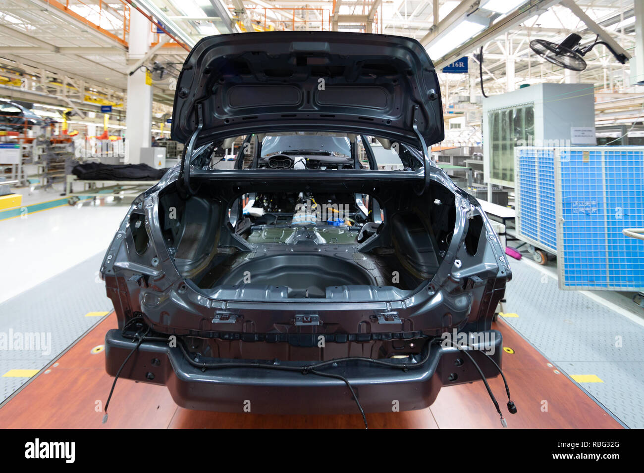 Add details to car body. Robotic equipment makes Assembly of car ...