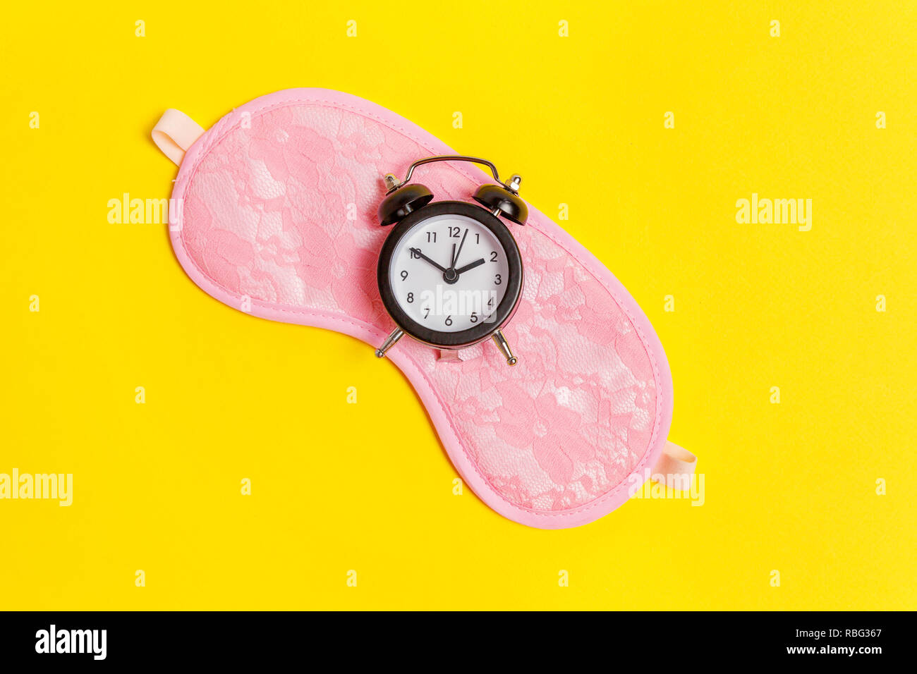 Sleeping eye mask, alarm clock isolated on yellow colourful trendy ...