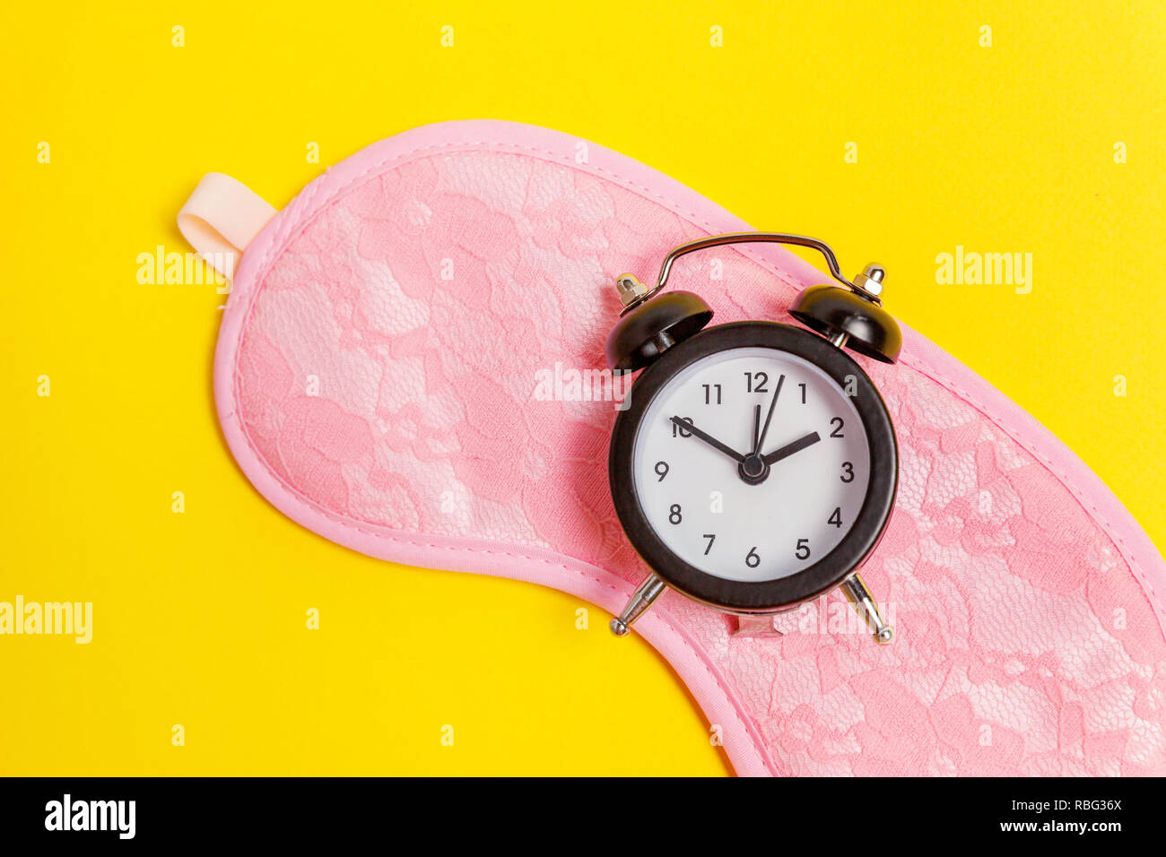 Sleeping eye mask, alarm clock isolated on yellow colourful trendy ...