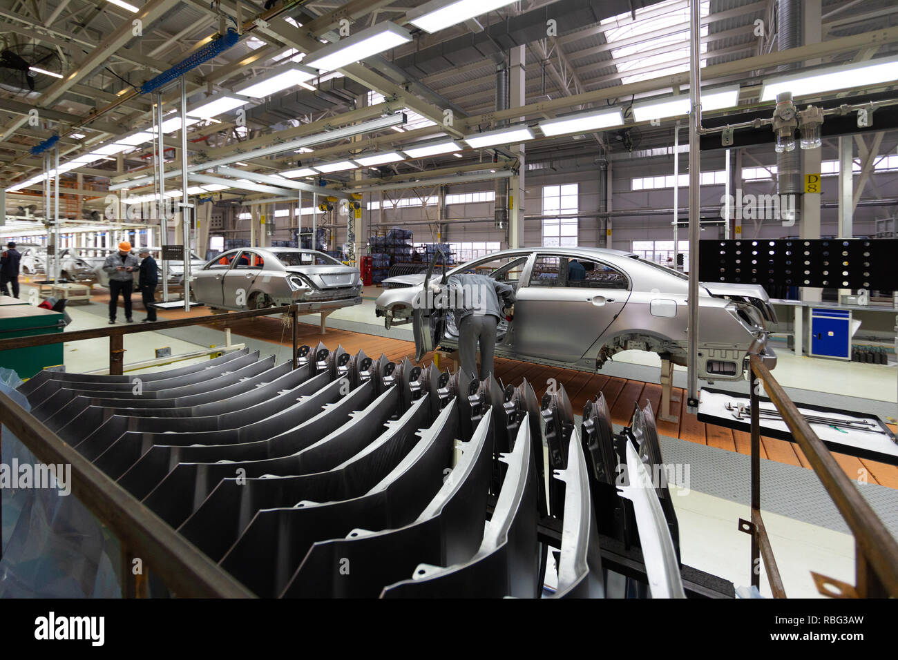 Workers assemble a vehicle body. process of welding cars. Modern ...