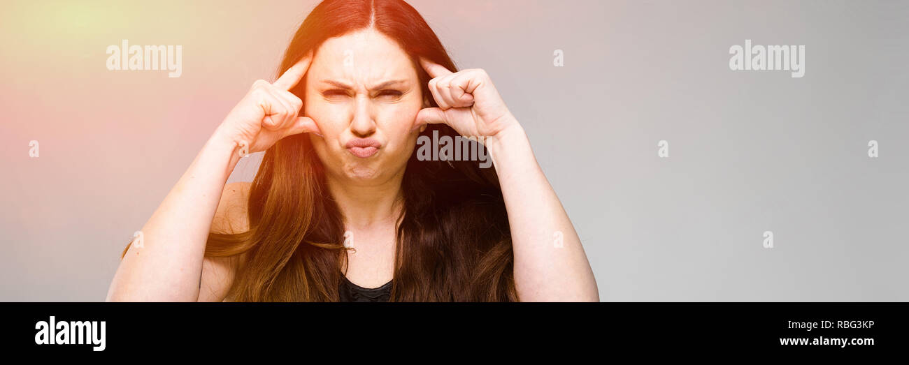 Emotional confident plus size model standing in studio angry fed up on ...