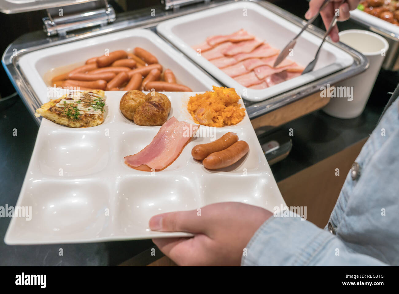 Man choosing food in the buffet banquet Stock Photo - Alamy