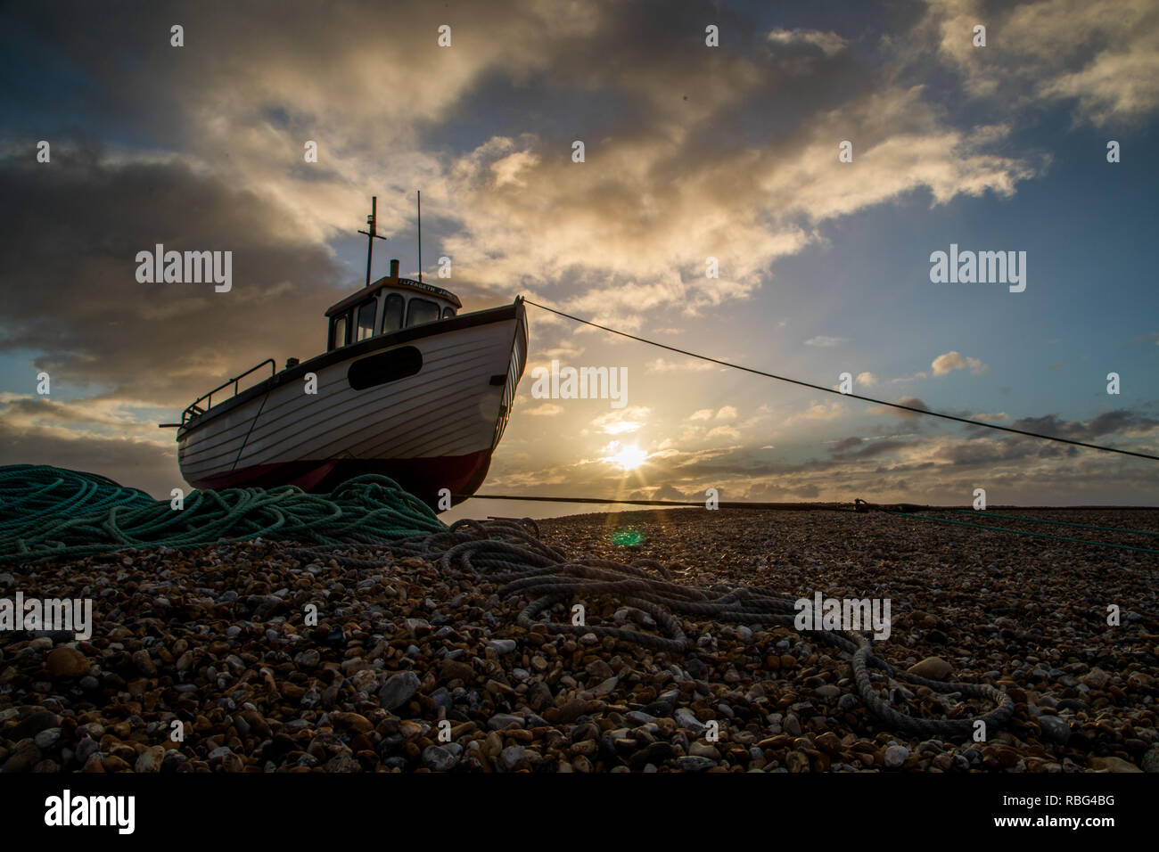 The sun rises above the fishing fleet based at Dungeness in Kent ...