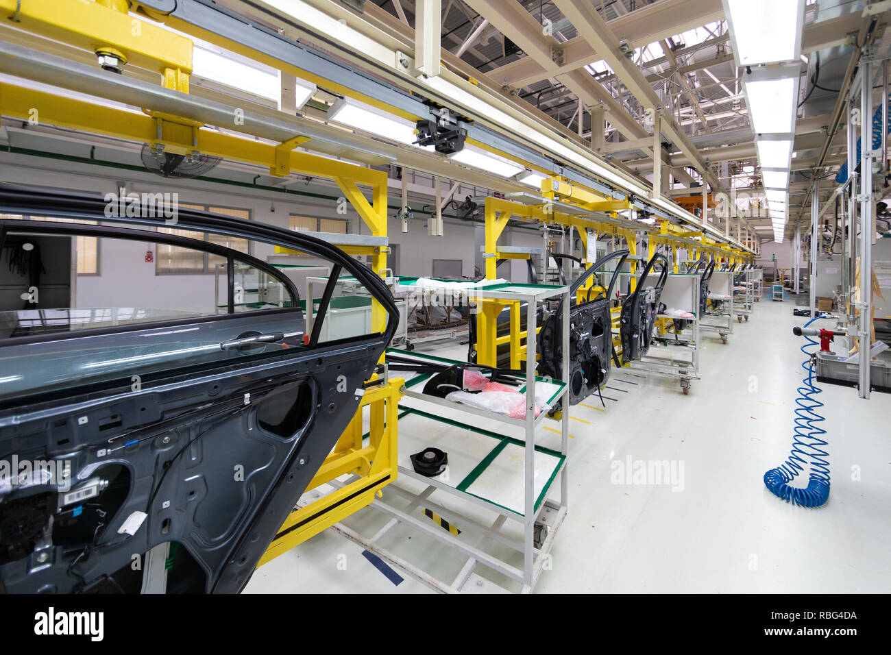 car door on conveyor. Robotic equipment makes Assembly of car. Modern car Assembly at factory ...