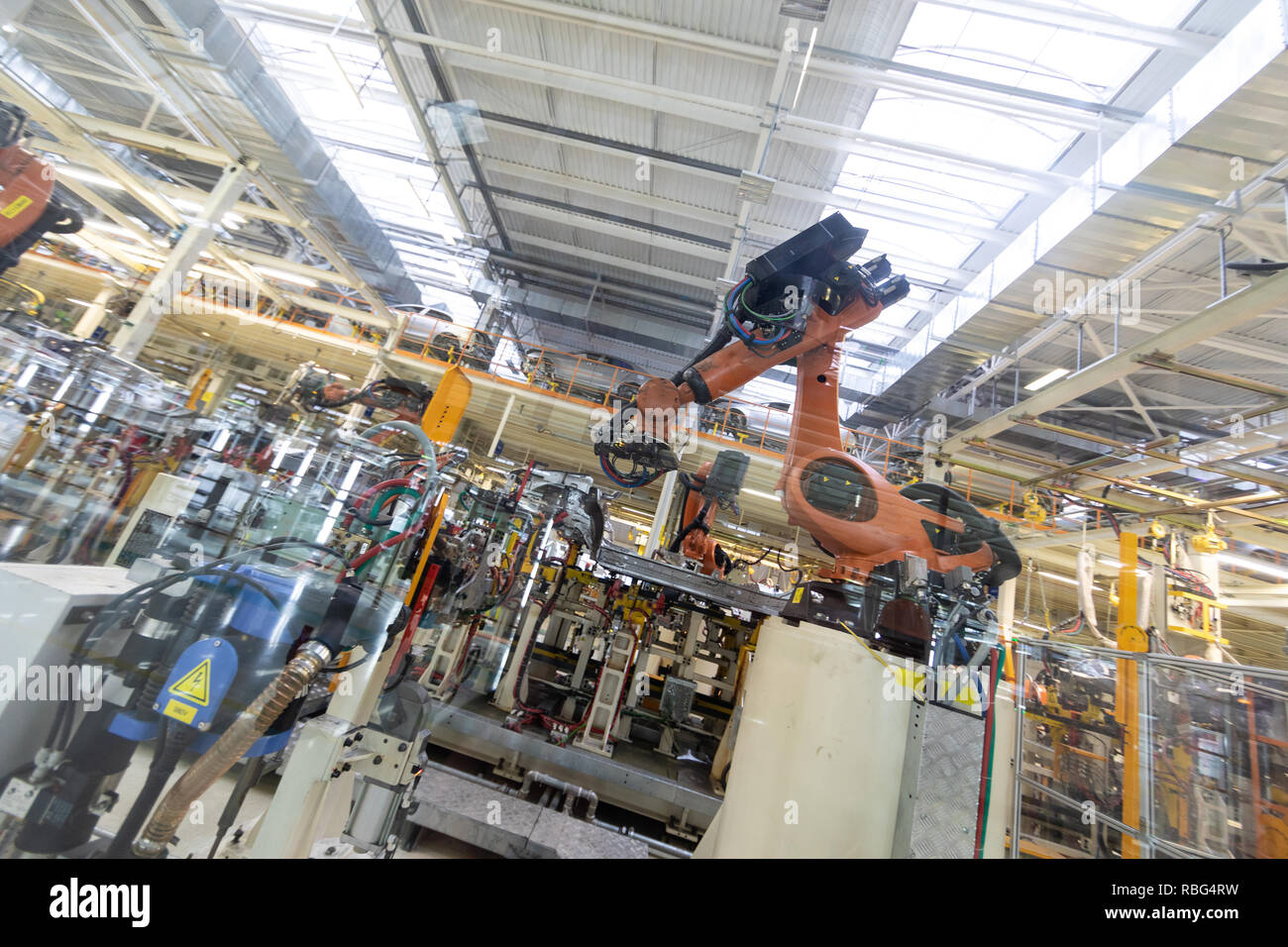 process of welding cars behind glass. Modern Assembly of cars at plant ...