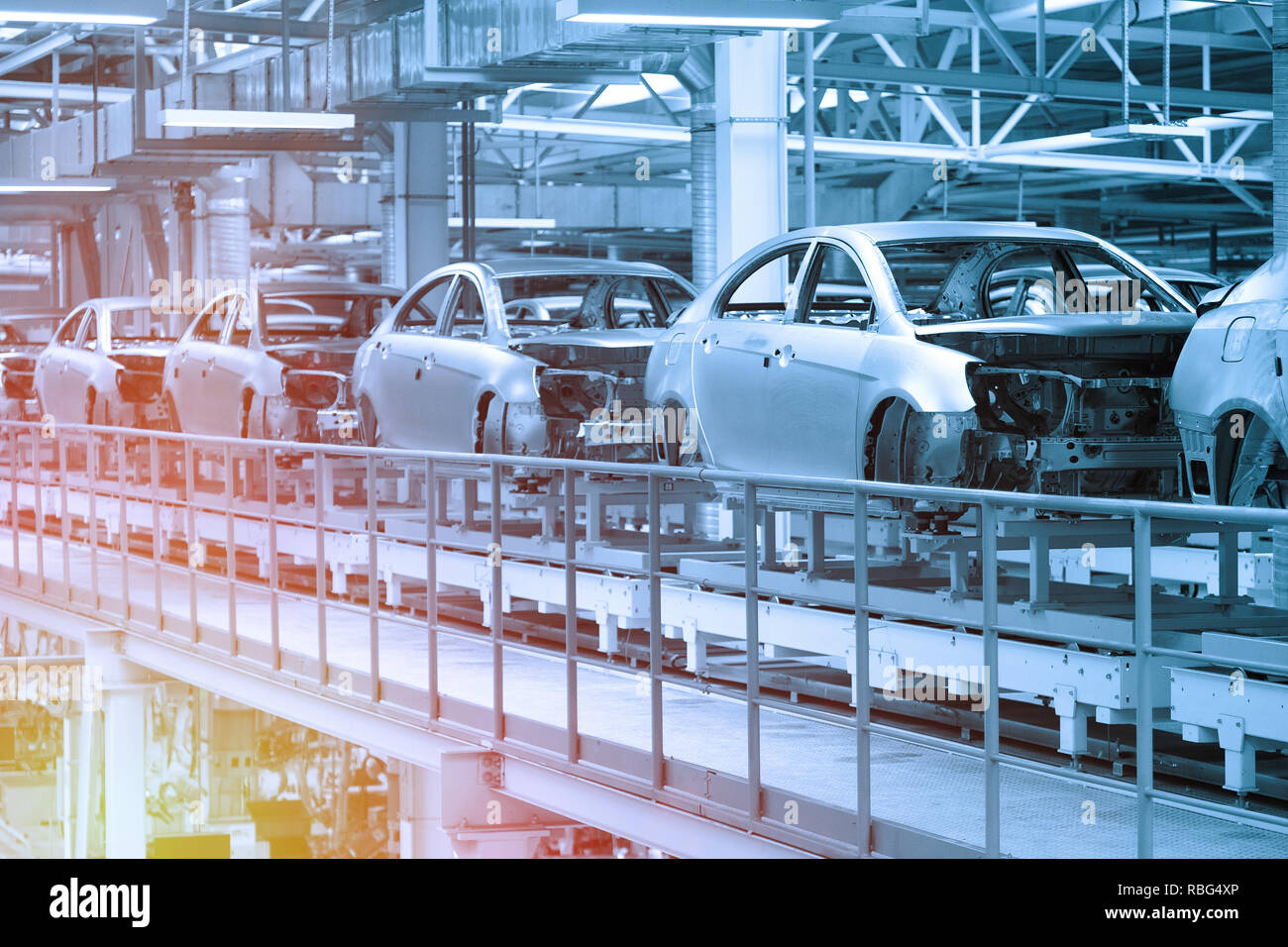 Car bodies are on Assembly line. Factory for production of cars in blue ...