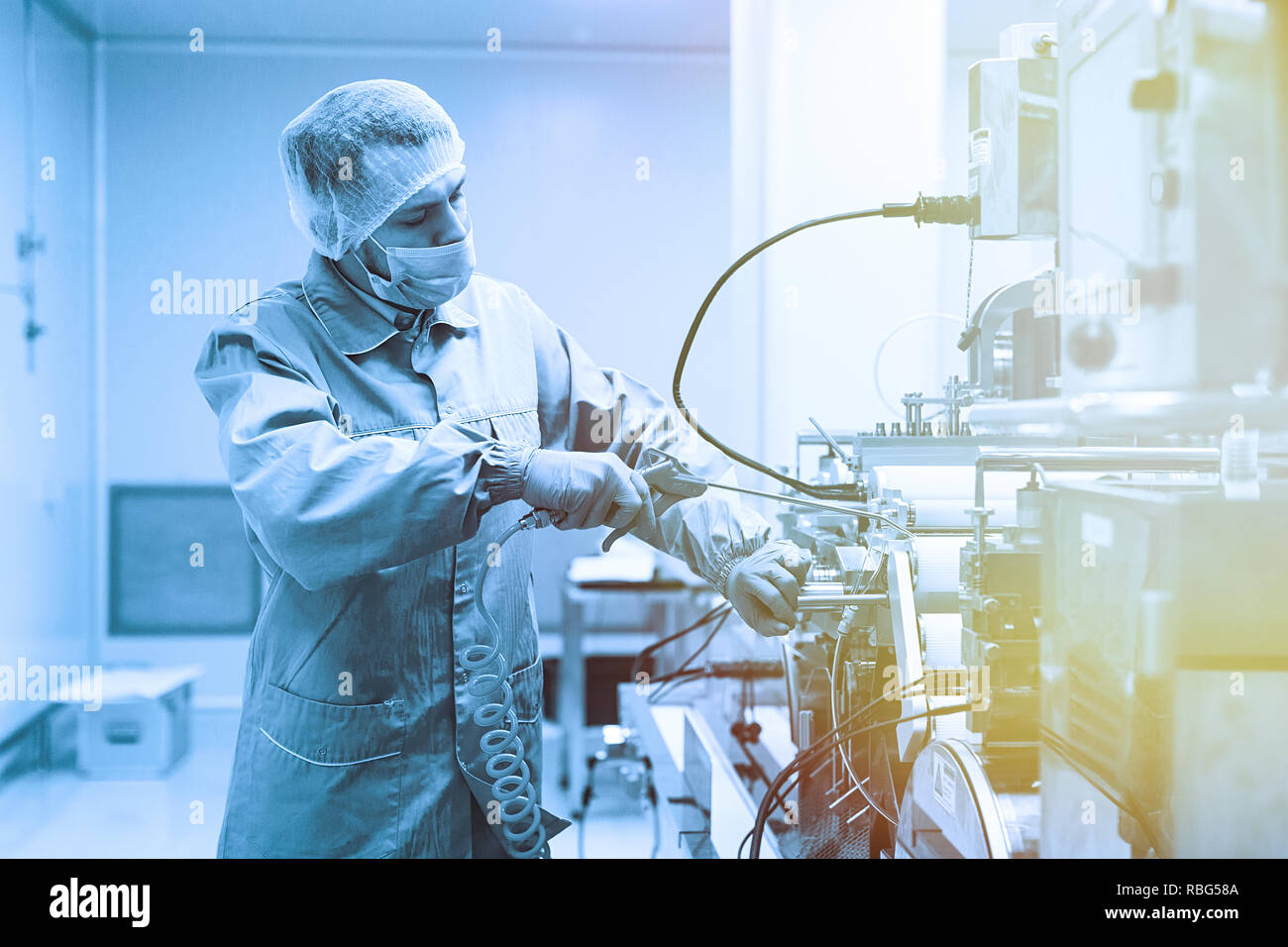 plant picture, factory worker is fixing machine, steel machines. Blue ...