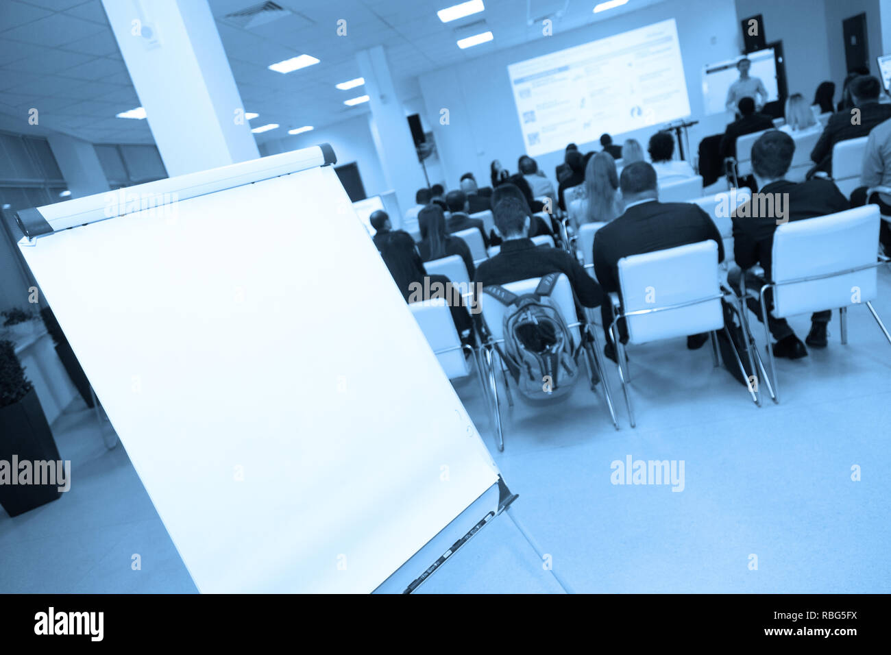 Board on background of audience in conference room. Business concept ...