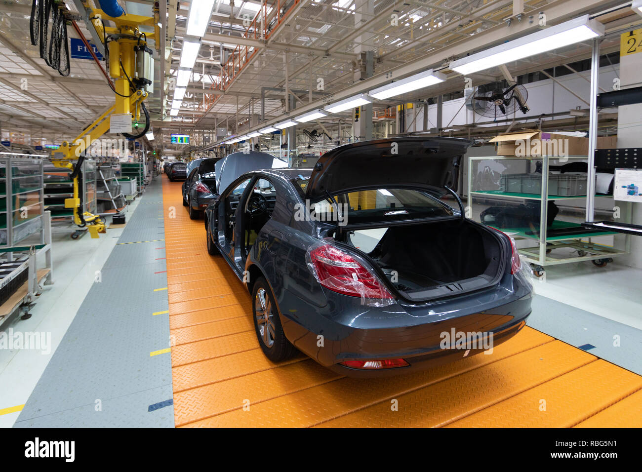 Assembled car is on the Assembly line. Robotic equipment makes the ...