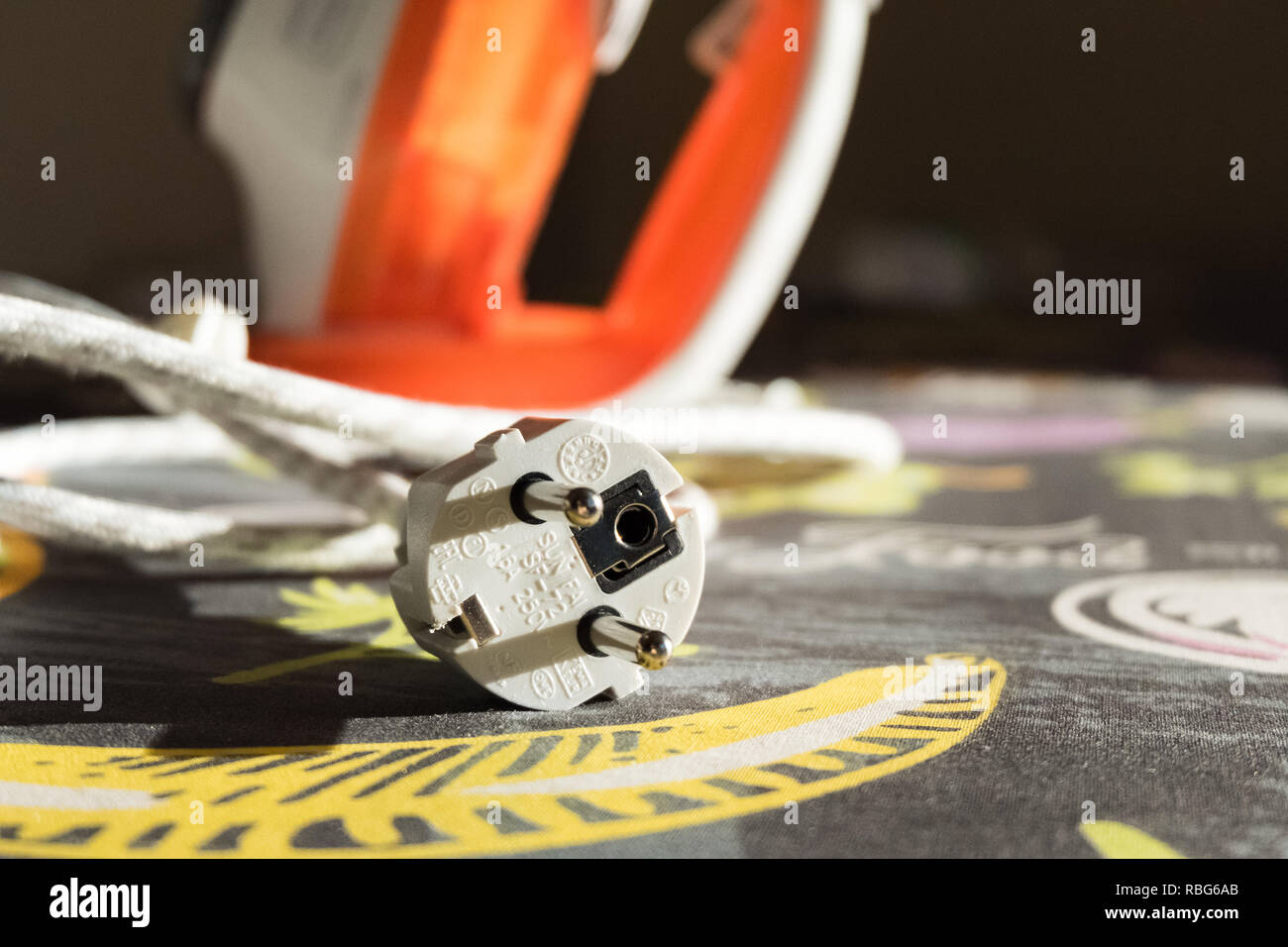 White iron plug against the backdrop of the iron in the house Stock ...