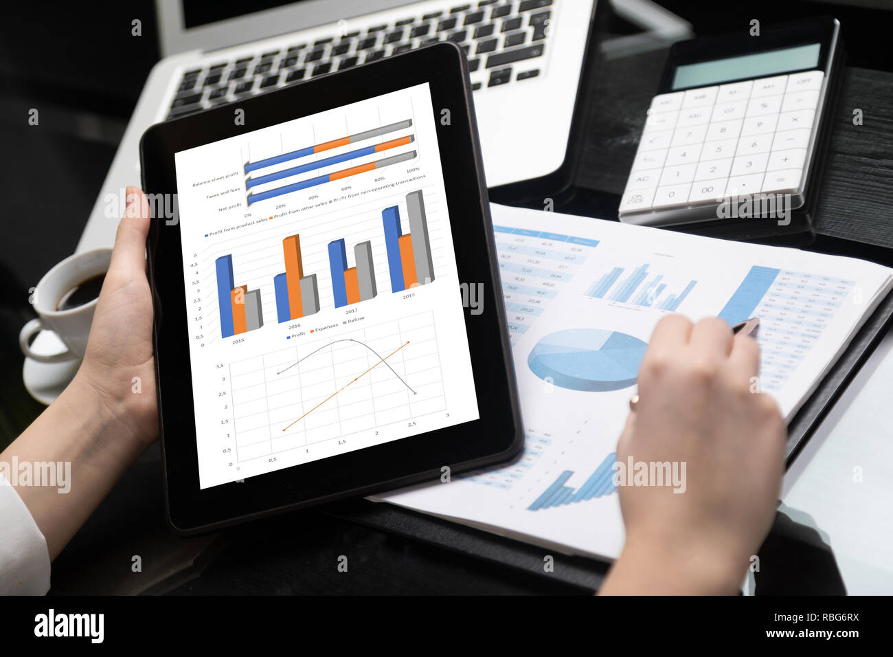 Close-up of hand holding tablet and point pen at chart Stock Photo - Alamy
