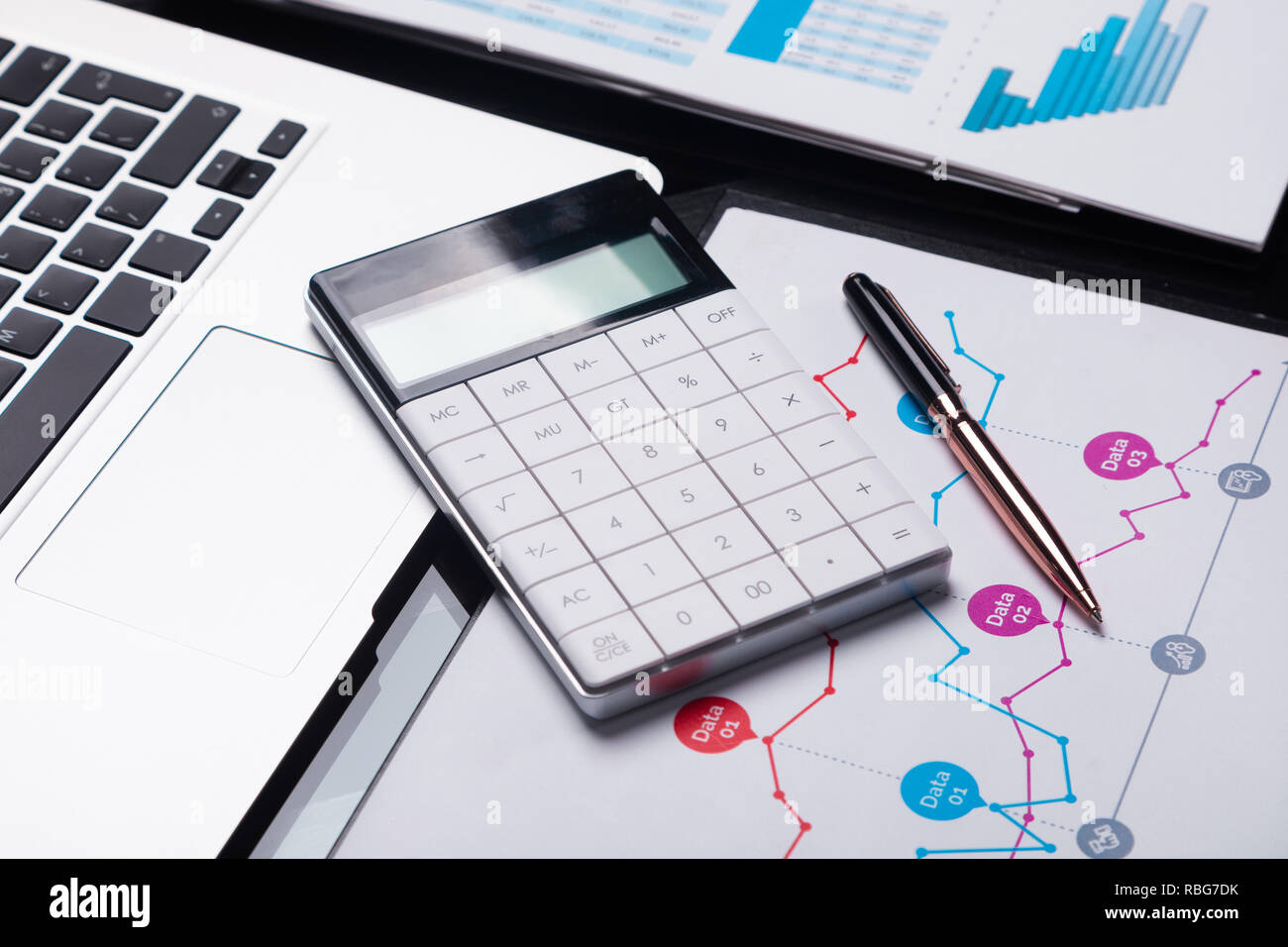 Modern calculator is on a laptop and on a sheet with a graph Stock ...