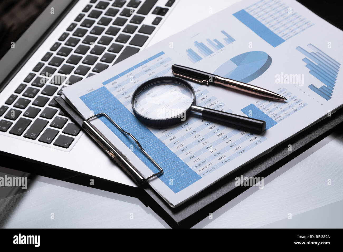Office workplace with magnifier and stationery Stock Photo - Alamy