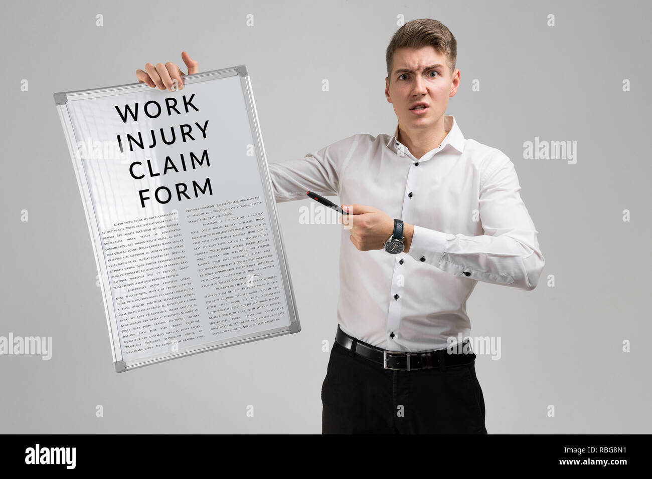 young man holding a form with a claim of injury at work isolated on a ...