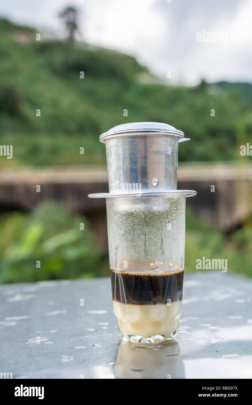 Traditional Vietnamese milk coffee with mountain forests background ...