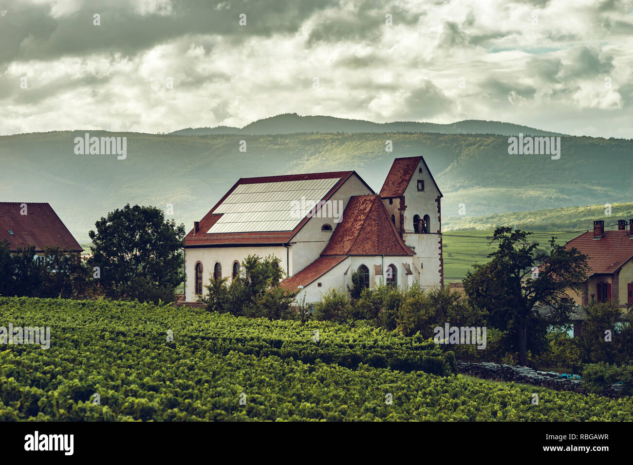 Photovoltaic panels on the church roof in Alsace, France. Religion and ...