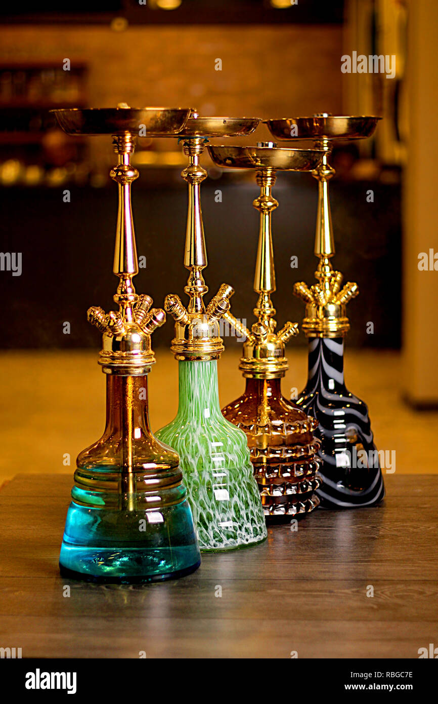 Golden hookahs on the table Stock Photo - Alamy