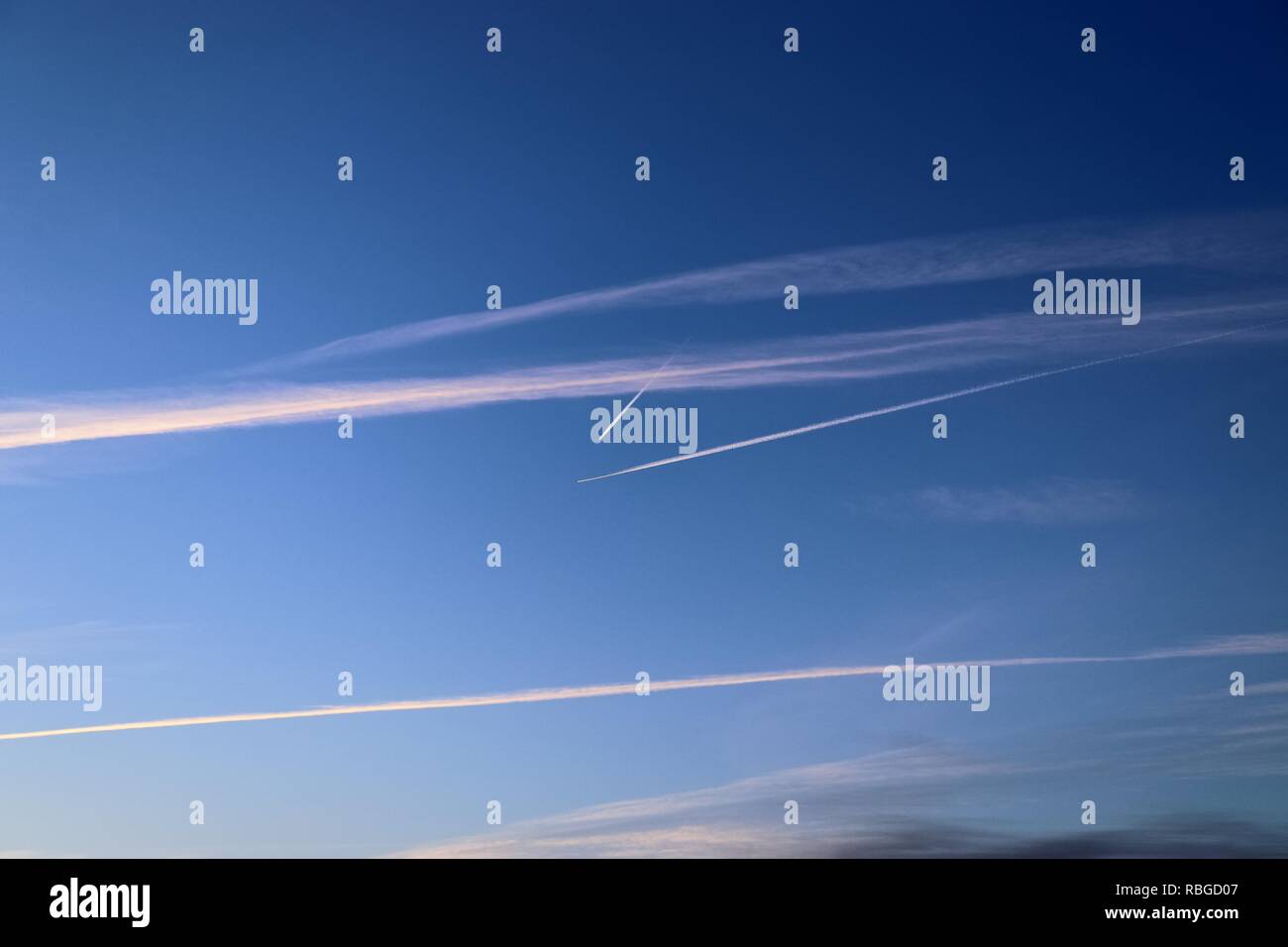 Aircraft and vapor contrails in the sky Stock Photo - Alamy