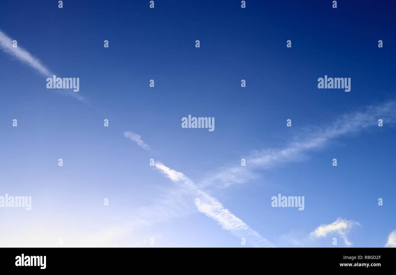 Aircraft and vapor contrails in the sky Stock Photo - Alamy
