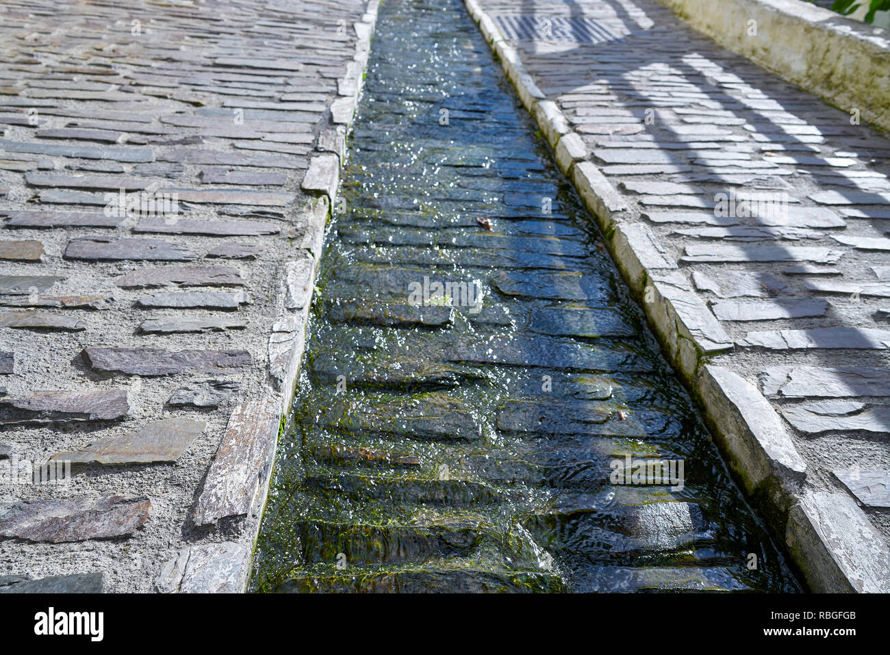Alpujarras street water stream flooding in the middle of floor in ...