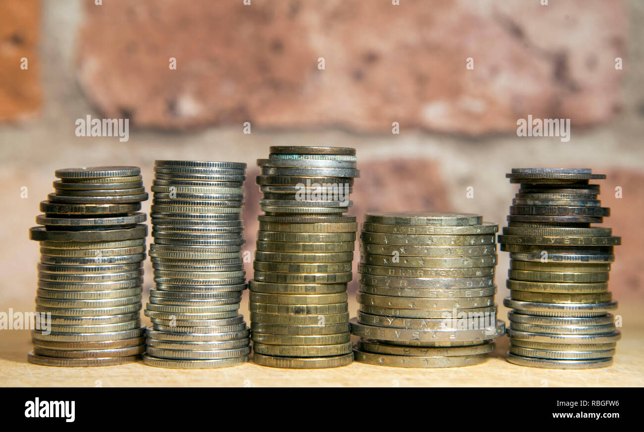 Stacks of coins and a vintage brick wall reverse Stock Photo - Alamy