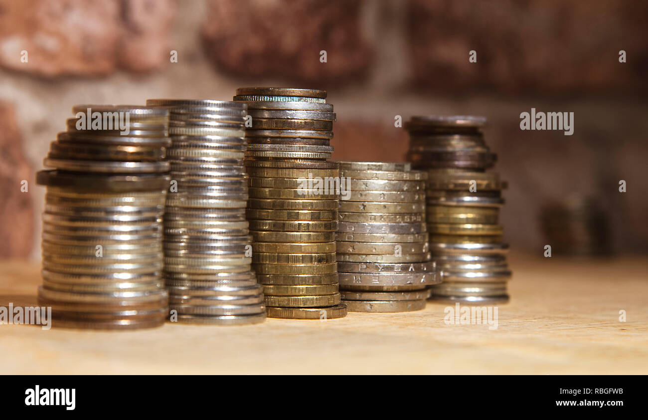 Stacks of coins and a vintage brick wall reverse Stock Photo - Alamy