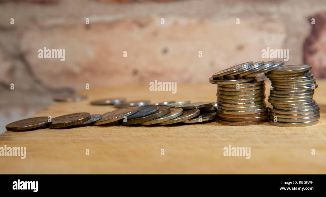 Stacks of coins and a vintage brick wall reverse Stock Photo - Alamy