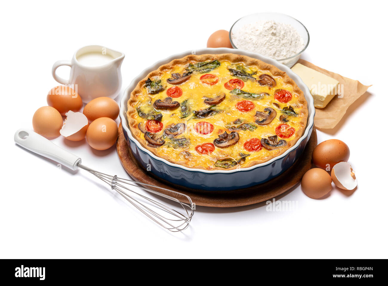 Baked homemade quiche pie in ceramic baking form, eggs and cream Stock ...