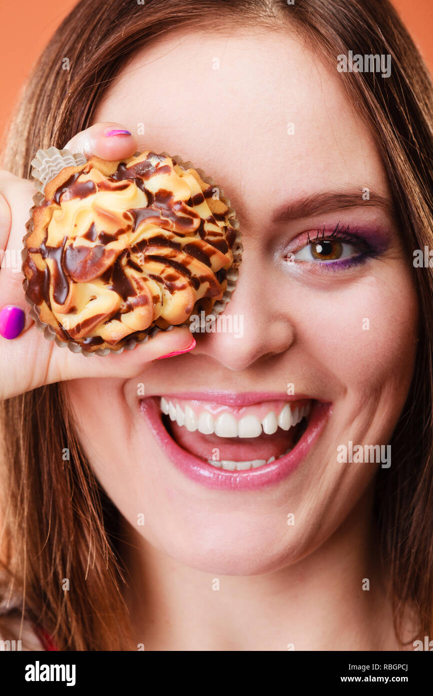 Diet sweet food and people concept. Funny woman holds cake in hand ...
