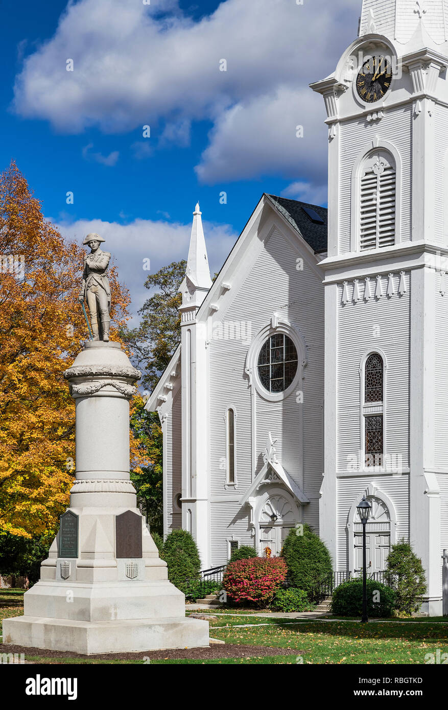 Congregational church clock tower and veterans memorial statue ...