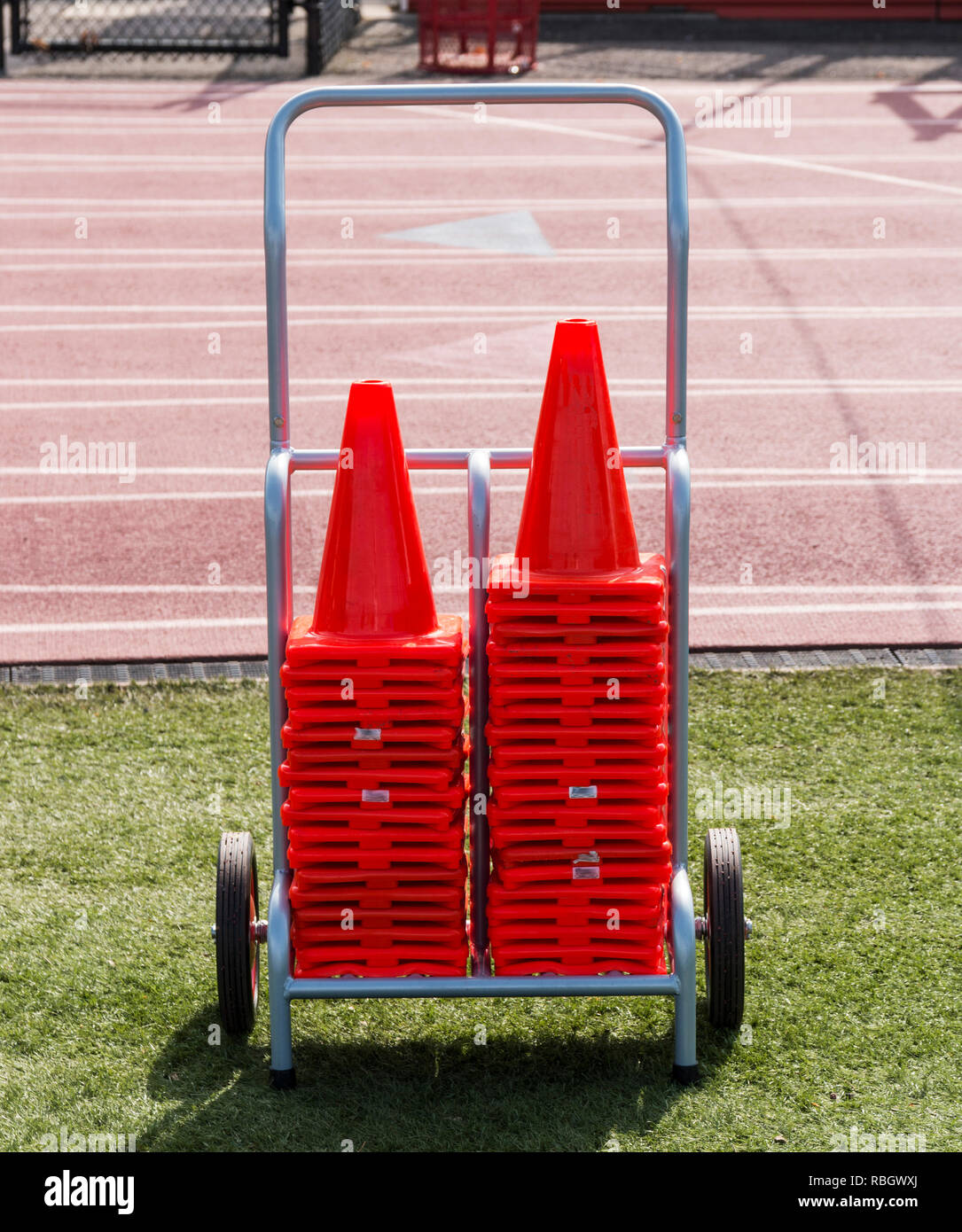 Orange cones are stored in a medal stand that can be wheeled to ...