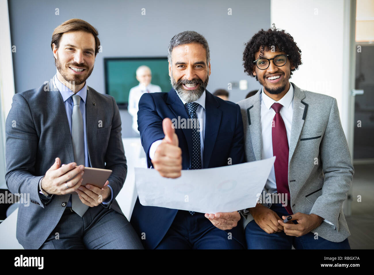 Successful company with happy workers in office Stock Photo - Alamy
