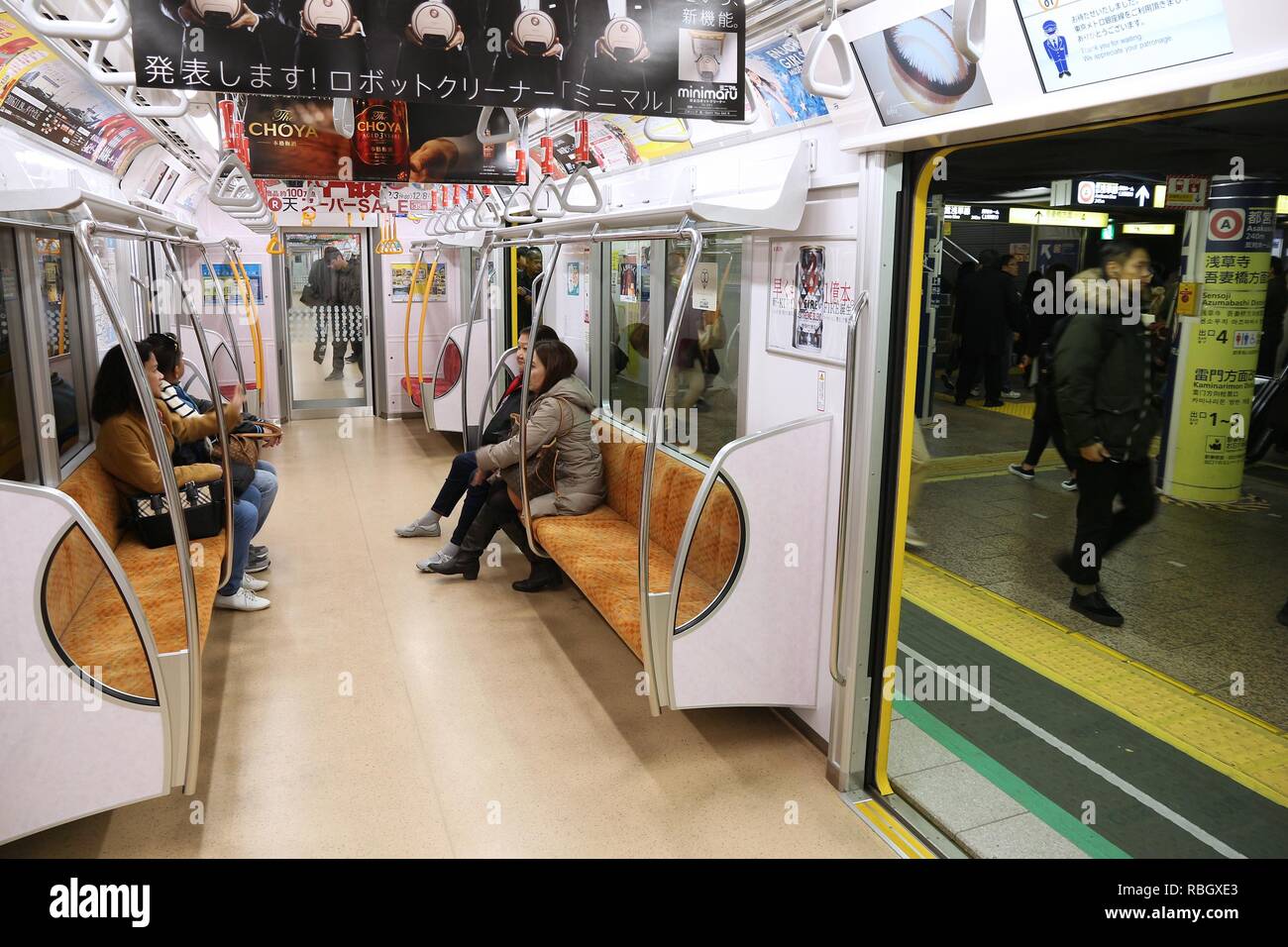TOKYO, JAPAN - DECEMBER 3, 2016: Passengers ride a metro train in Tokyo ...