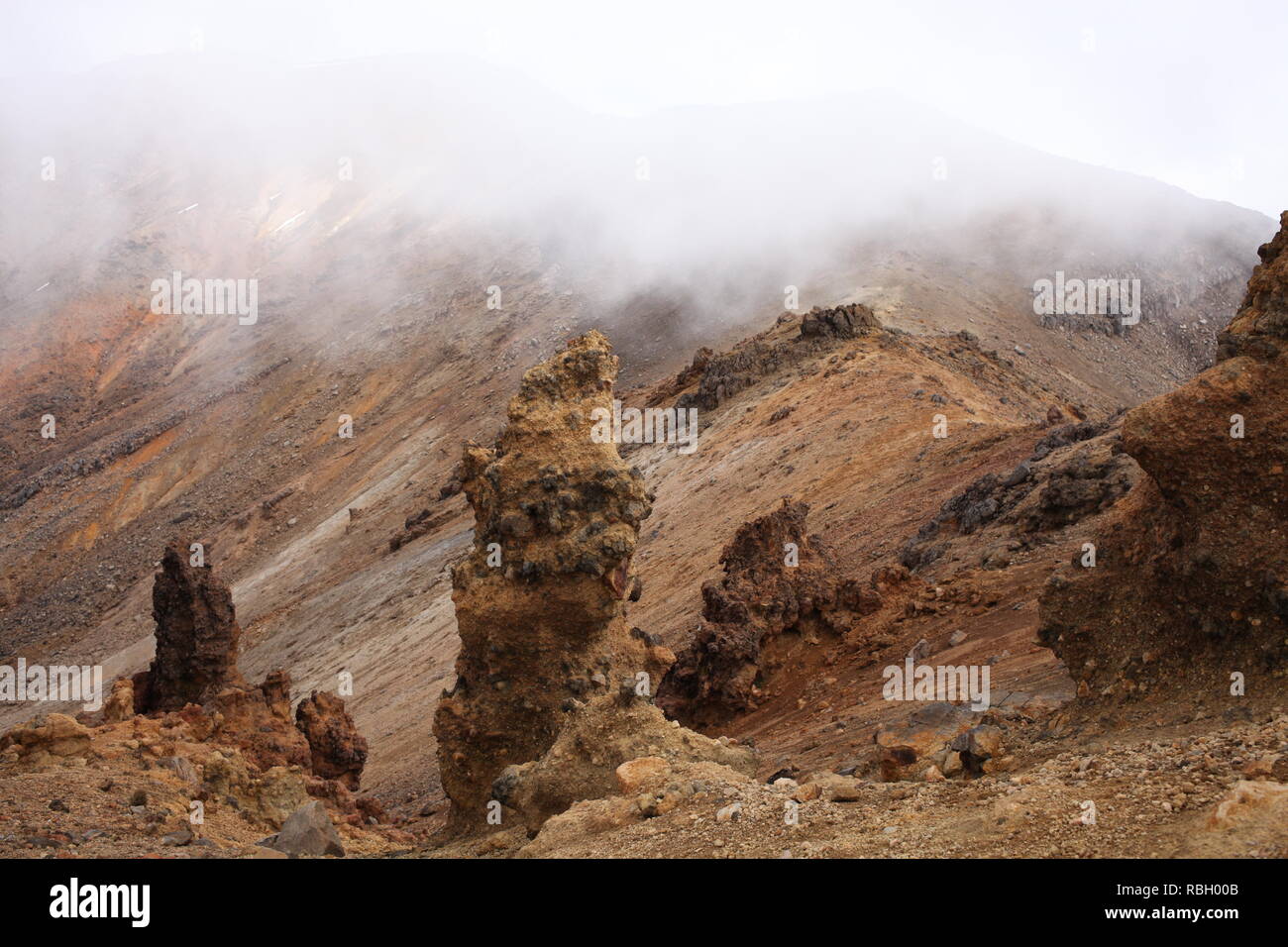 Red rock formations in crater with mist Stock Photo - Alamy