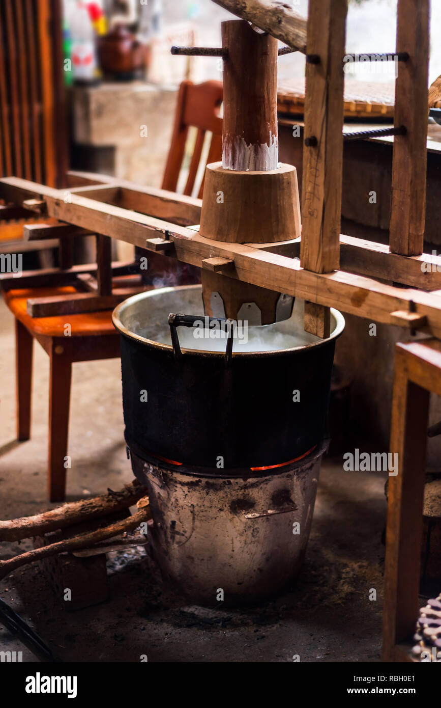 Traditional noodles in making on a vintage manual wooden machine Stock ...
