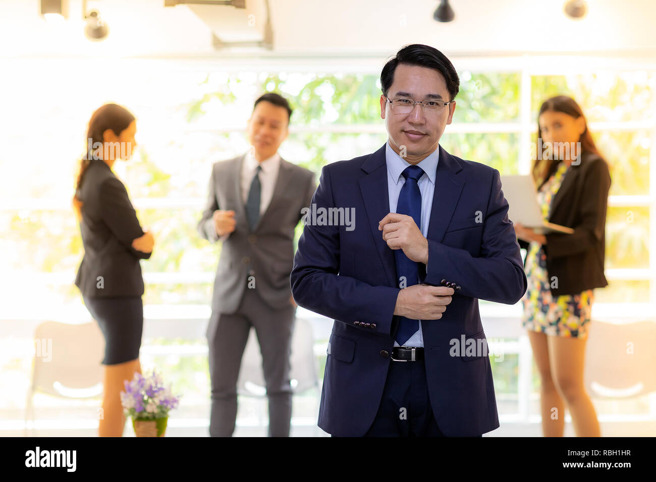 Portrait of Businessman with business team in background using for ...