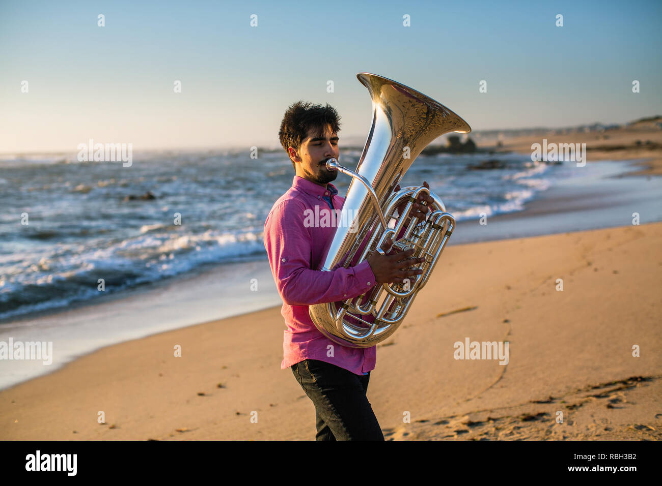 Musician play to tuba on the Sea shore Stock Photo - Alamy