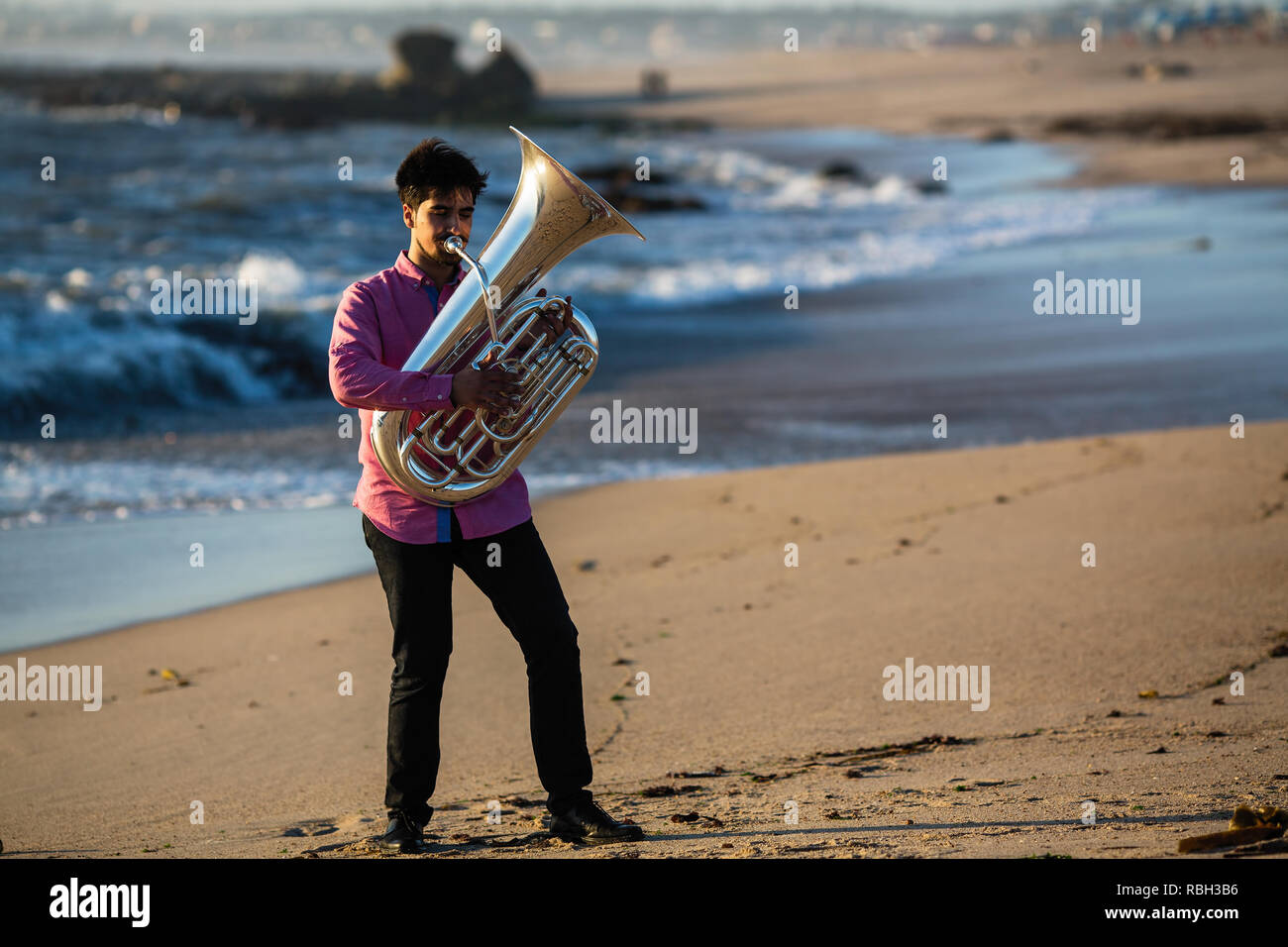 Musician play to tuba on the Sea shore Stock Photo - Alamy