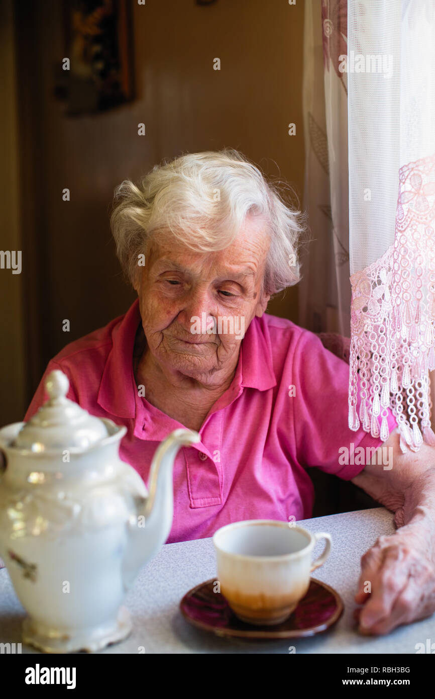 Elderly grandmother drinks tea in her house Stock Photo - Alamy