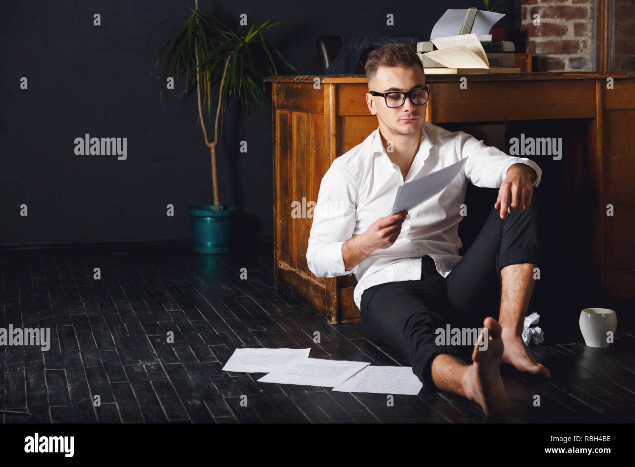 Handsome writer man wearing glasses and white shirt sitting on the ...