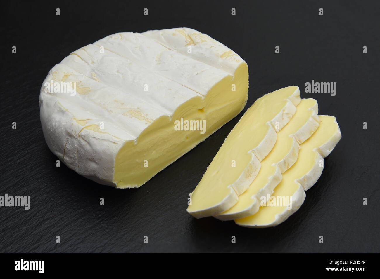 Camembert. Soft creamy cheese sliced on dark background Stock Photo - Alamy