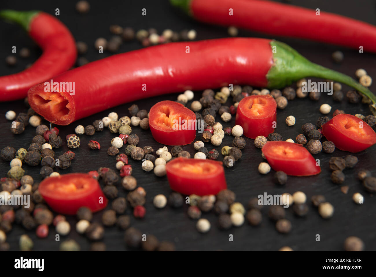 Red hot chili pepper cut into slices. With mixed peppercorns Stock ...