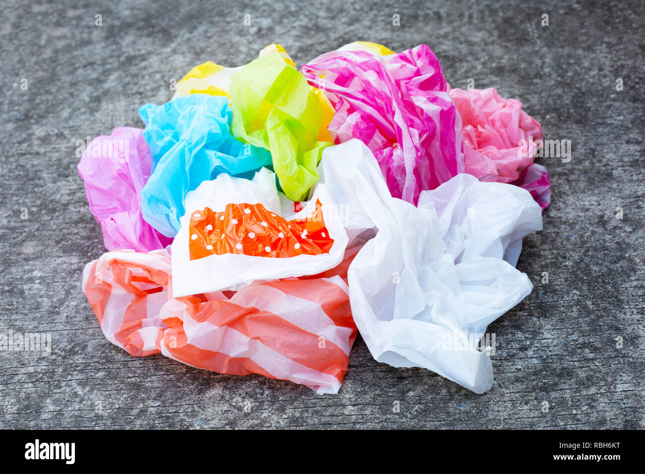 Plastic bags waste on cement floor background Stock Photo - Alamy