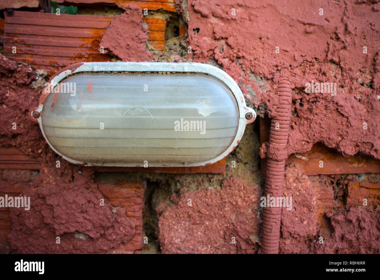 Elongated Lighting Fixture Mounted on Unfinished Wall. Flexible ...