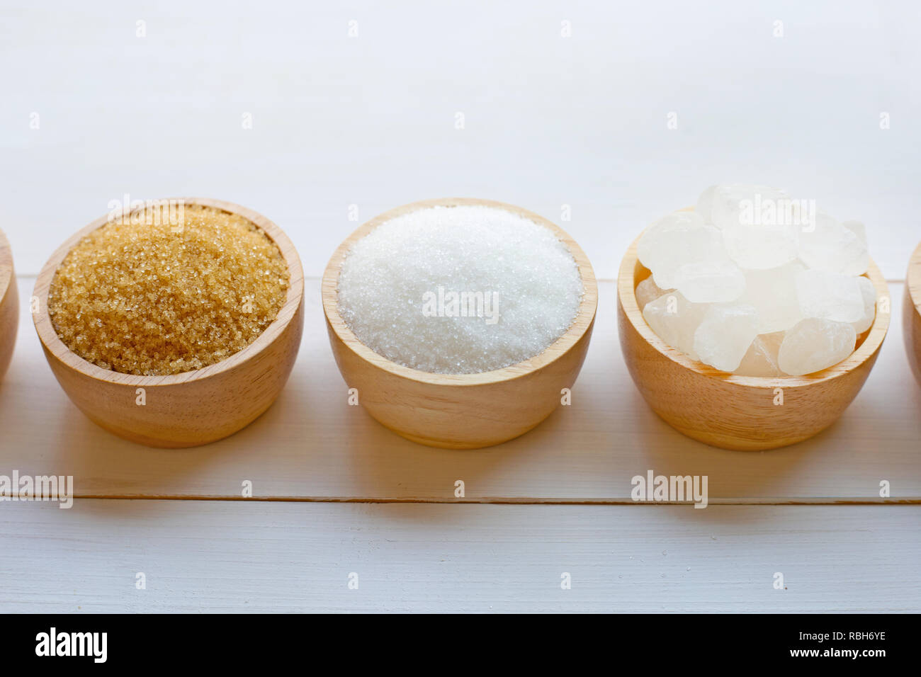 Various types of sugar on wooden background. Over white Stock Photo - Alamy