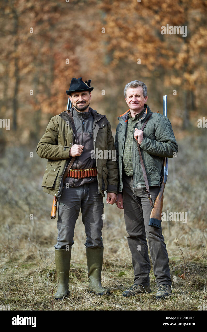 Two hunters together in the forest with double barrel guns Stock Photo ...